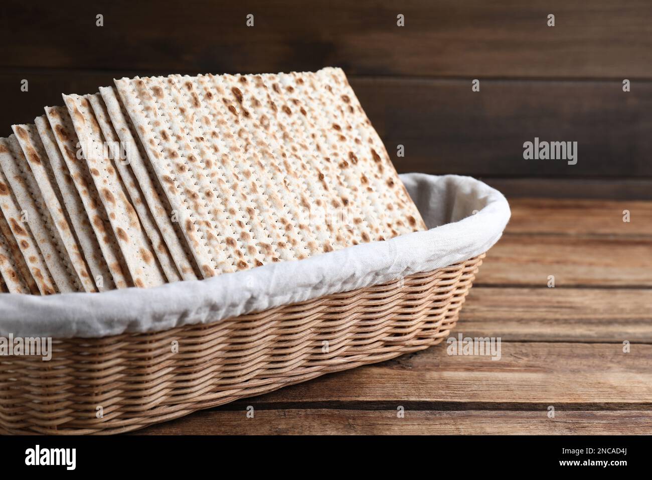Traditional matzos in basket on wooden table Stock Photo - Alamy