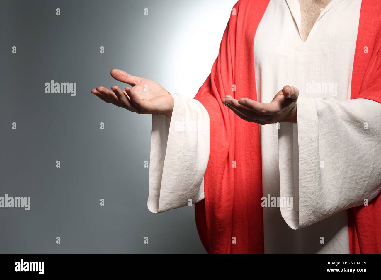 Jesus Christ reaching out his hands on grey background, closeup Stock ...