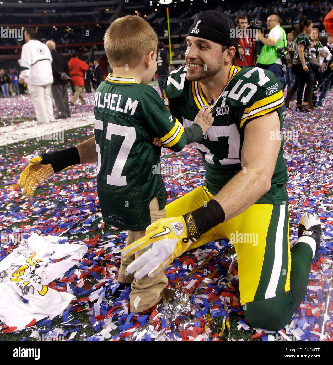 Green Bay Packers' Matt Wilhelm celebrates with his son Mason after ...
