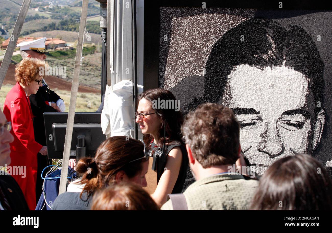 Former first lady Nancy Reagan, left, walks past a portrait of her ...