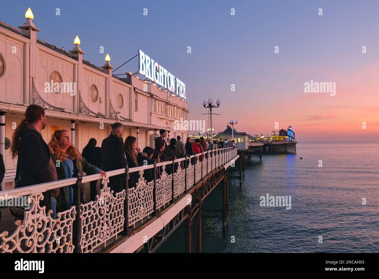 Brighton, UK. 14th February, 2023. Visitors look out from Brighton ...