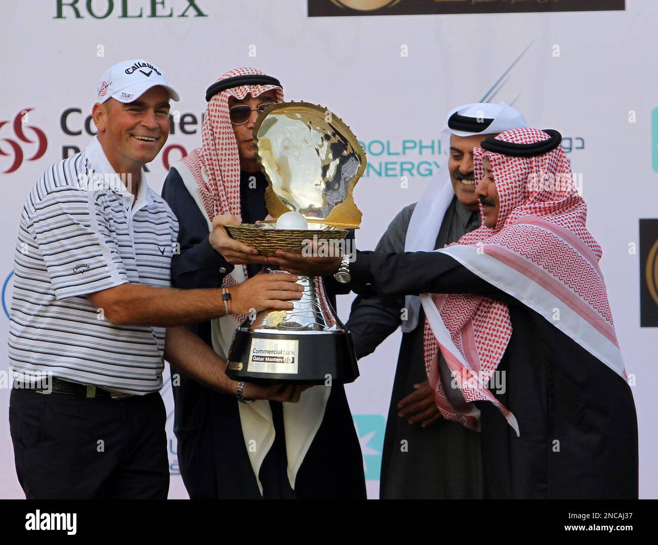 Thomas Bjorn of Denmark, left, receives the winner's trophy after ...