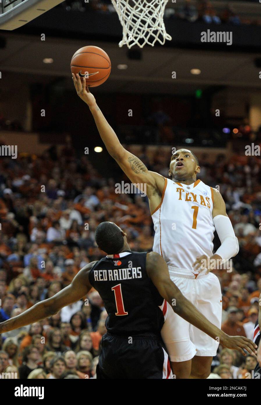 Texas forward Gary Johnson, left, lays the ball up against Texas Tech ...