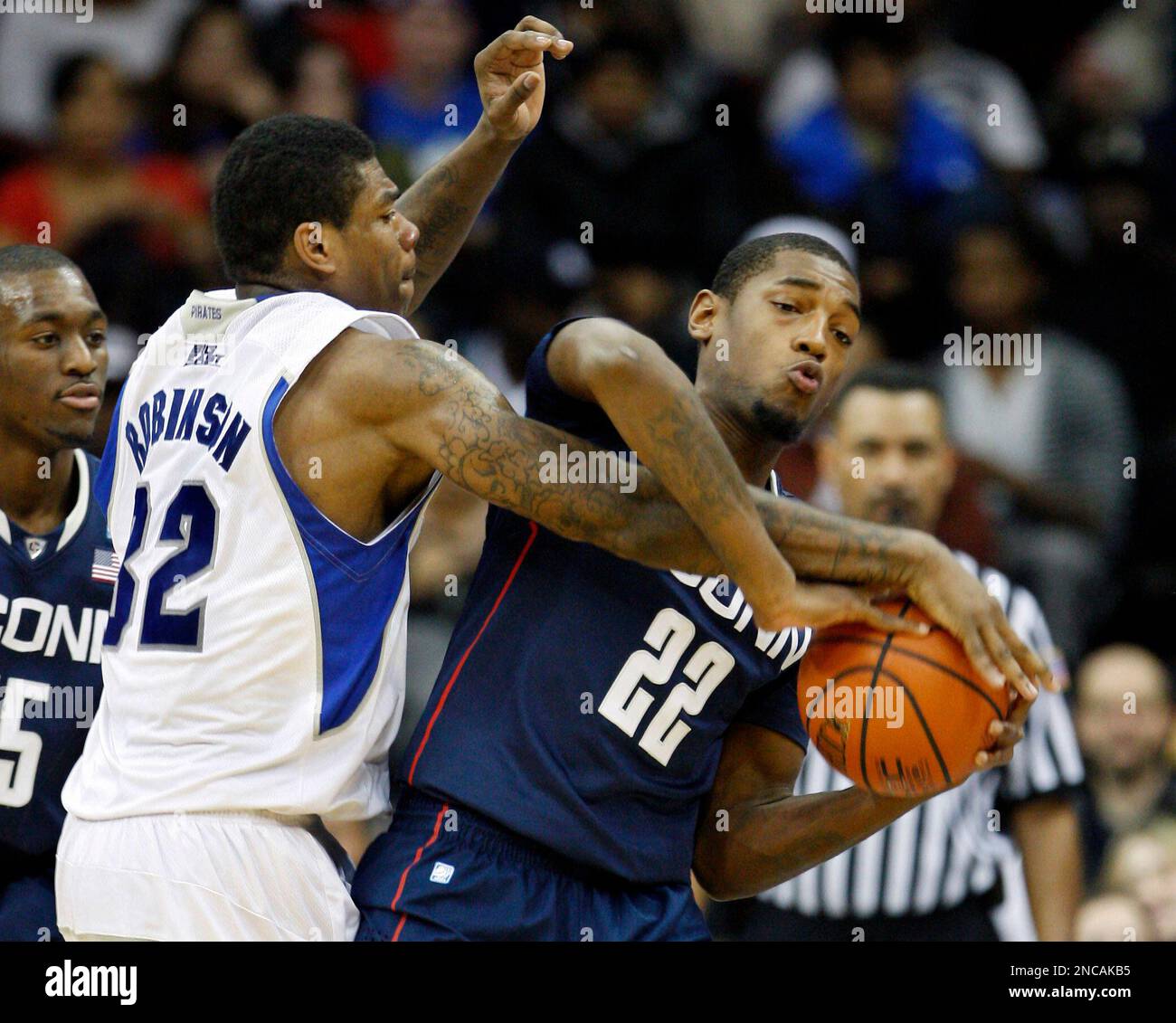 Seton Hall's Jeff Robinson (32) gets tangled with Connecticut's Roscoe ...