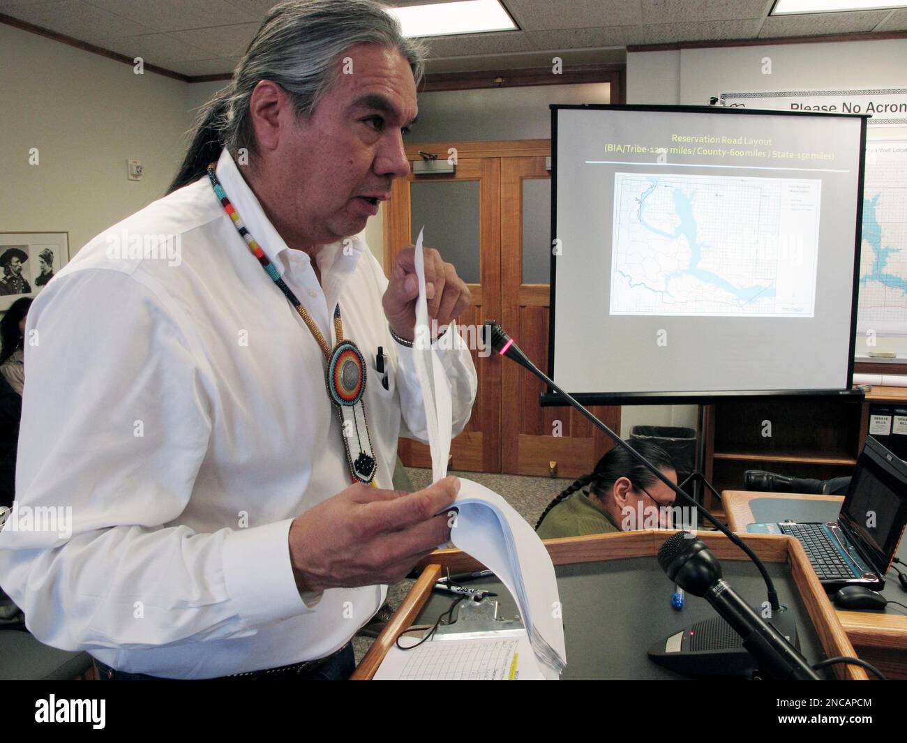 Tex Hall, chairman of the Three Affiliated Tribes, goes through papers ...