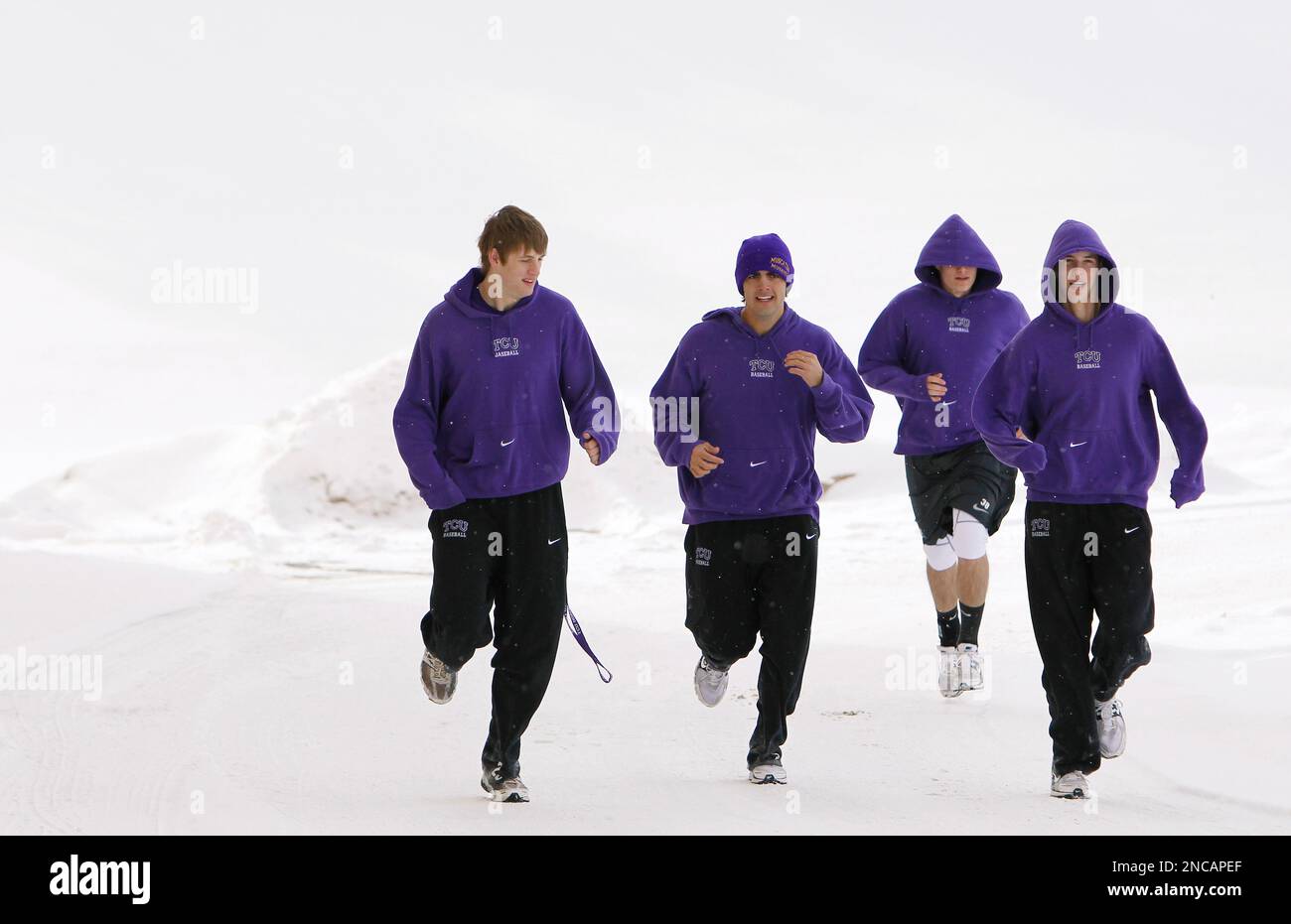 Members of the Texas Christian University baseball team go for a run in ...