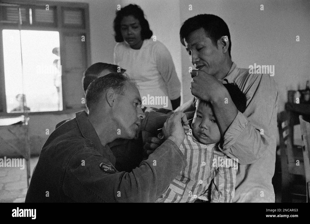 SFC Willie D. Henry from Lake Jackson, Texas treating AP CoCo villagers in Saigon, Vietnam on ...