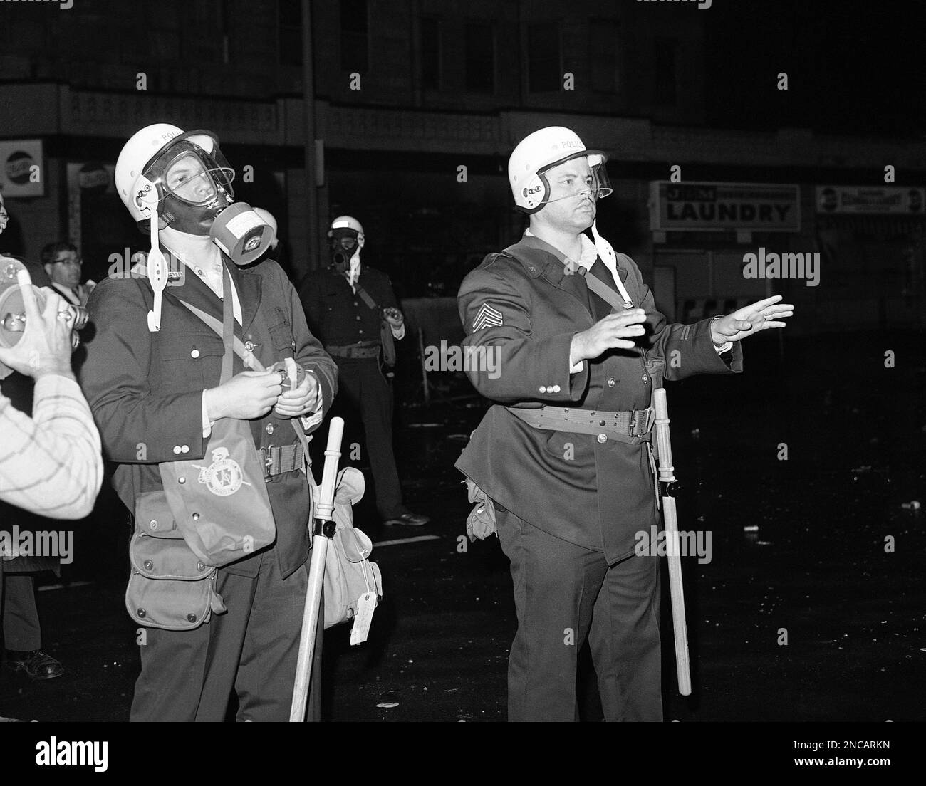 Police fire tear gas to scatter crowd at 14th and Euclid Streets in an ...