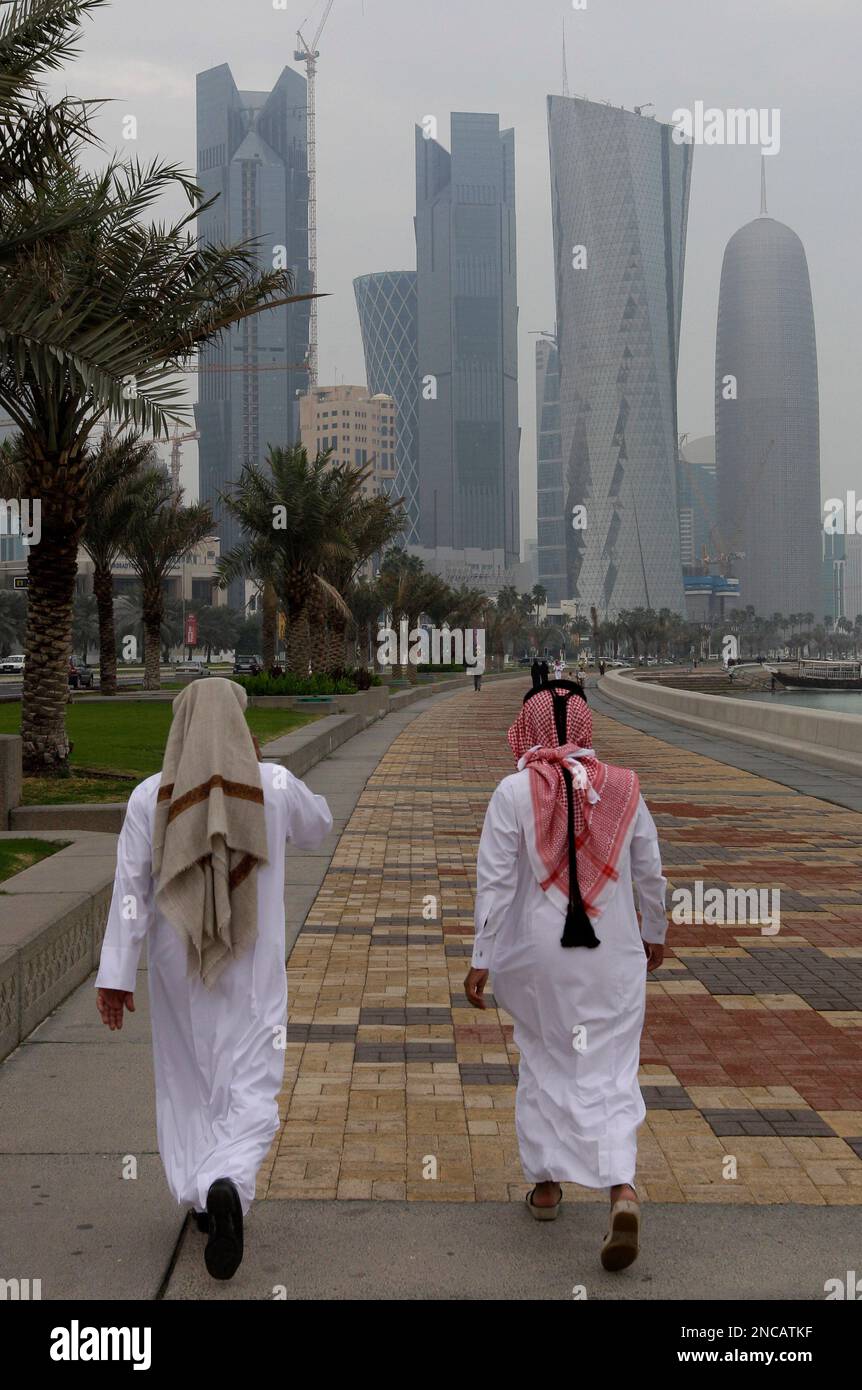 FILE - In this Jan. 21, 2011 file photo, two Qatari men, walk at the ...