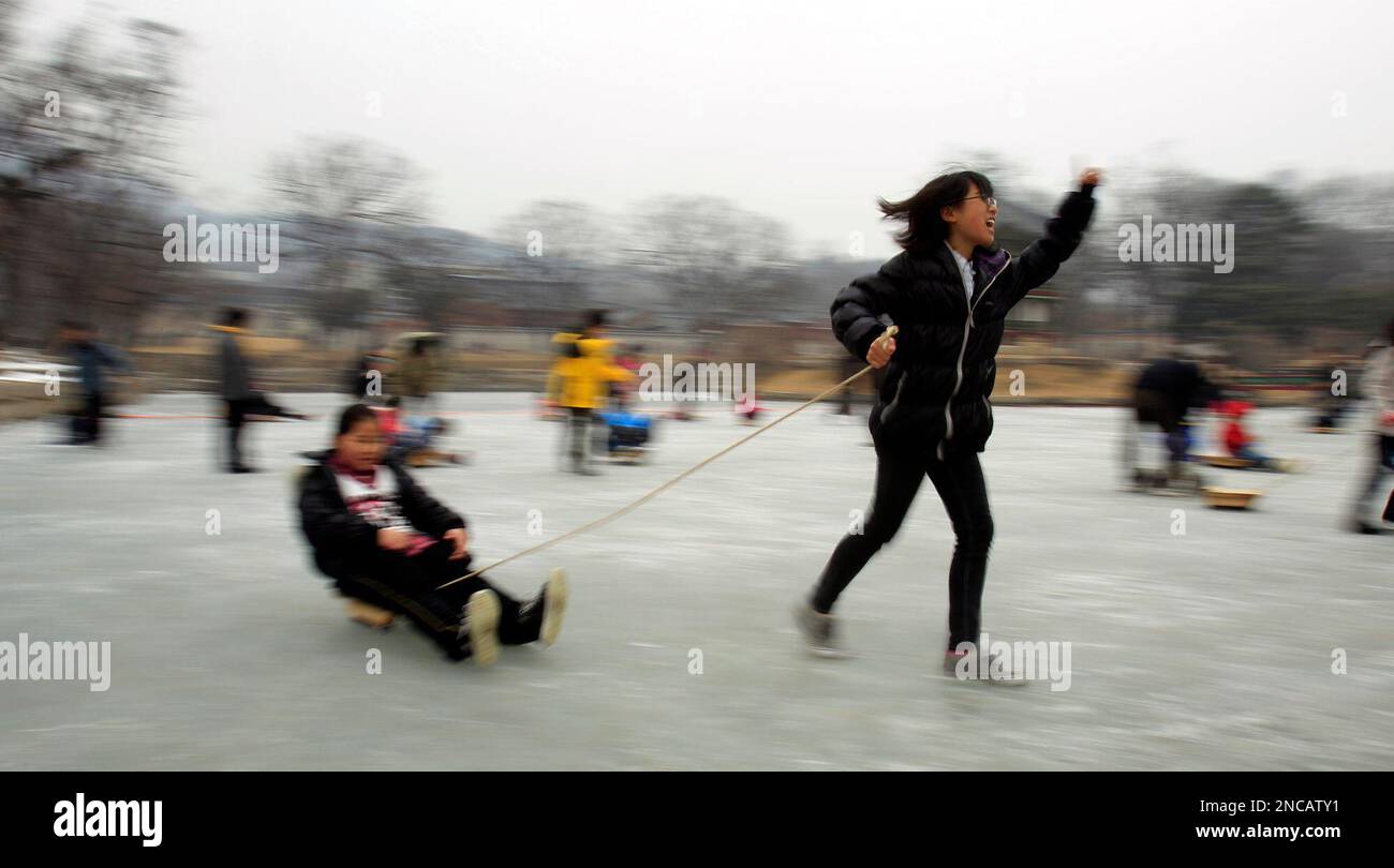 South Koreans ride on ice sleds at the 14th-century Gyeongbok Palace in ...