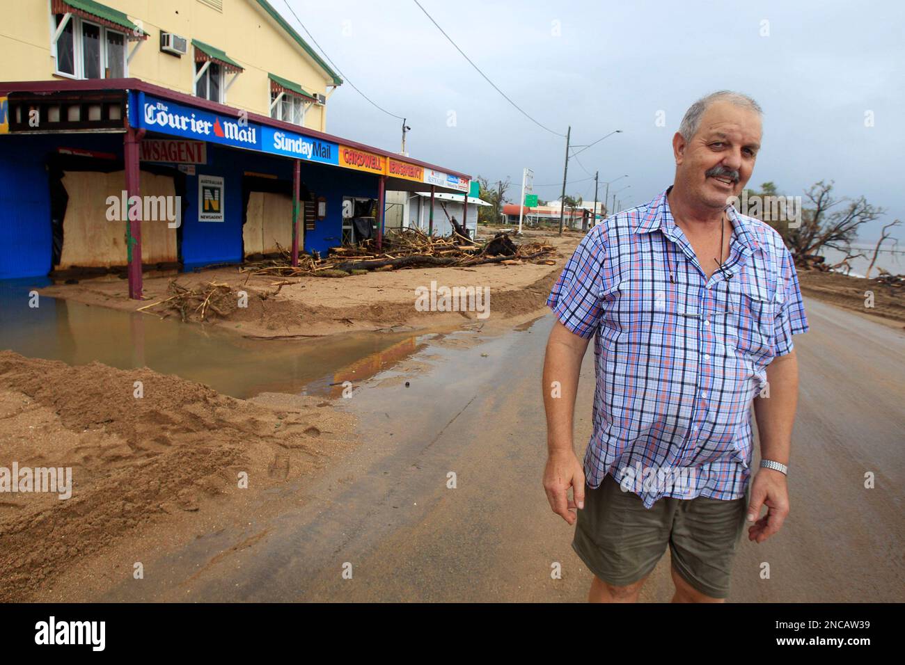 Richard Doran surveys the street in front of his shop in Cardwell ...