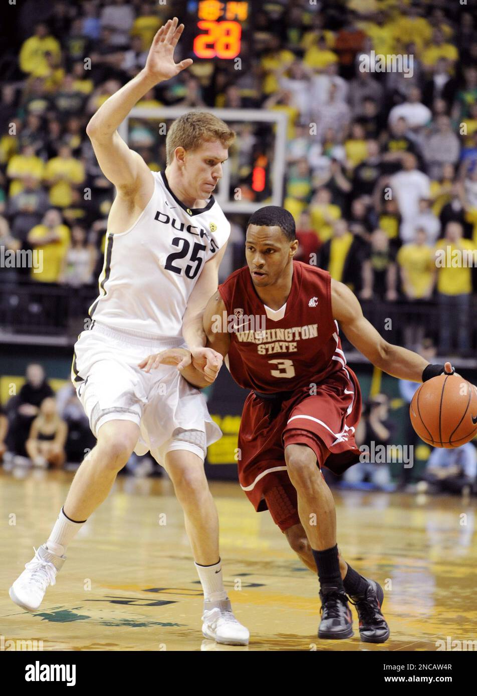 Washington State's Reggie Moore (3) drives against Oregon's E.J ...