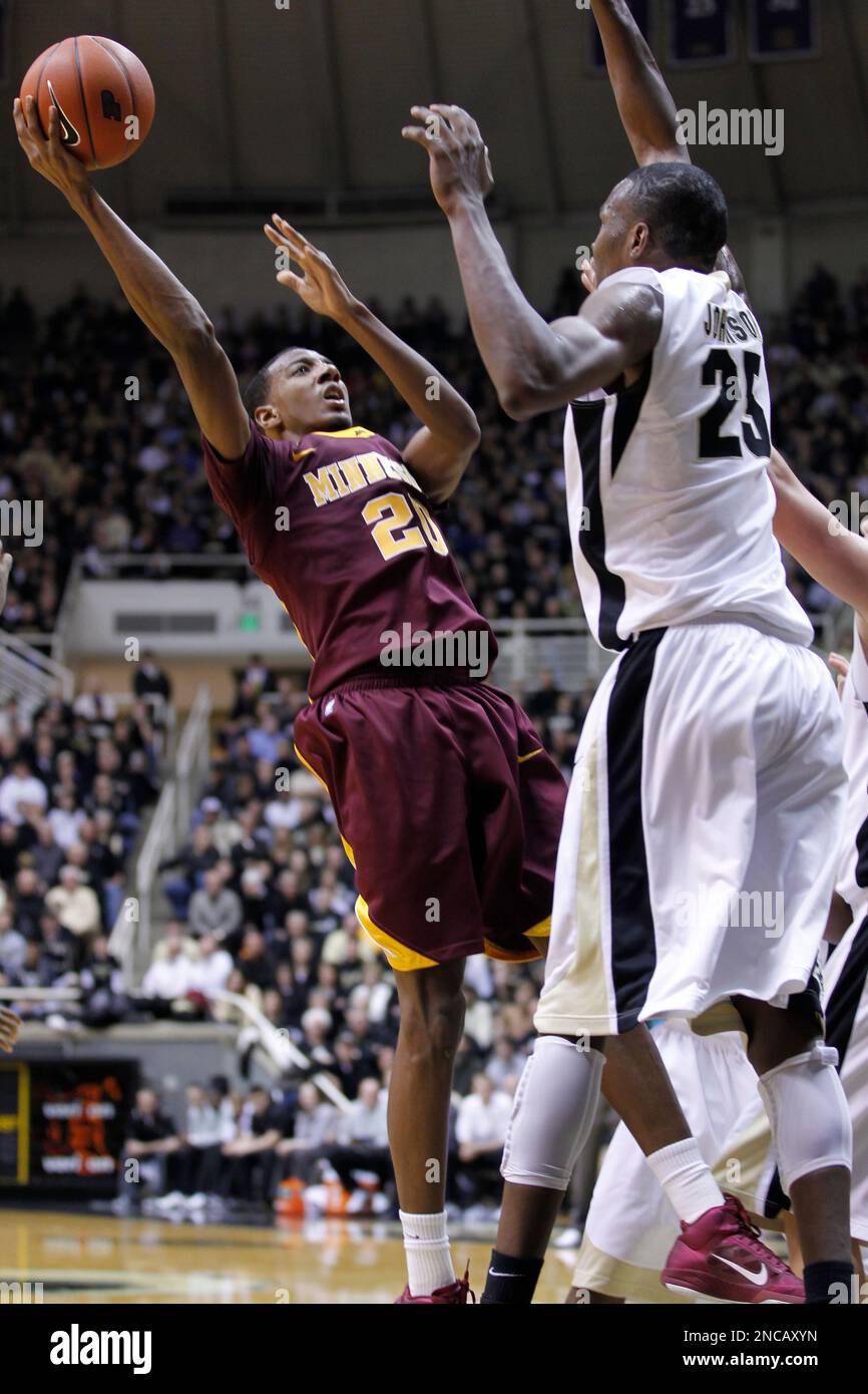 Minnesota guard Austin Hollins, left, shoots over Purdue center JaJuan ...