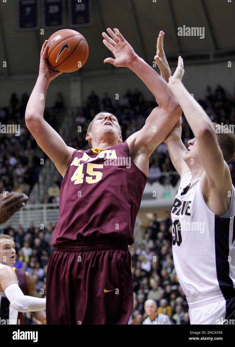 Minnesota center Colton Iverson, left, shoots over Purdue forward ...