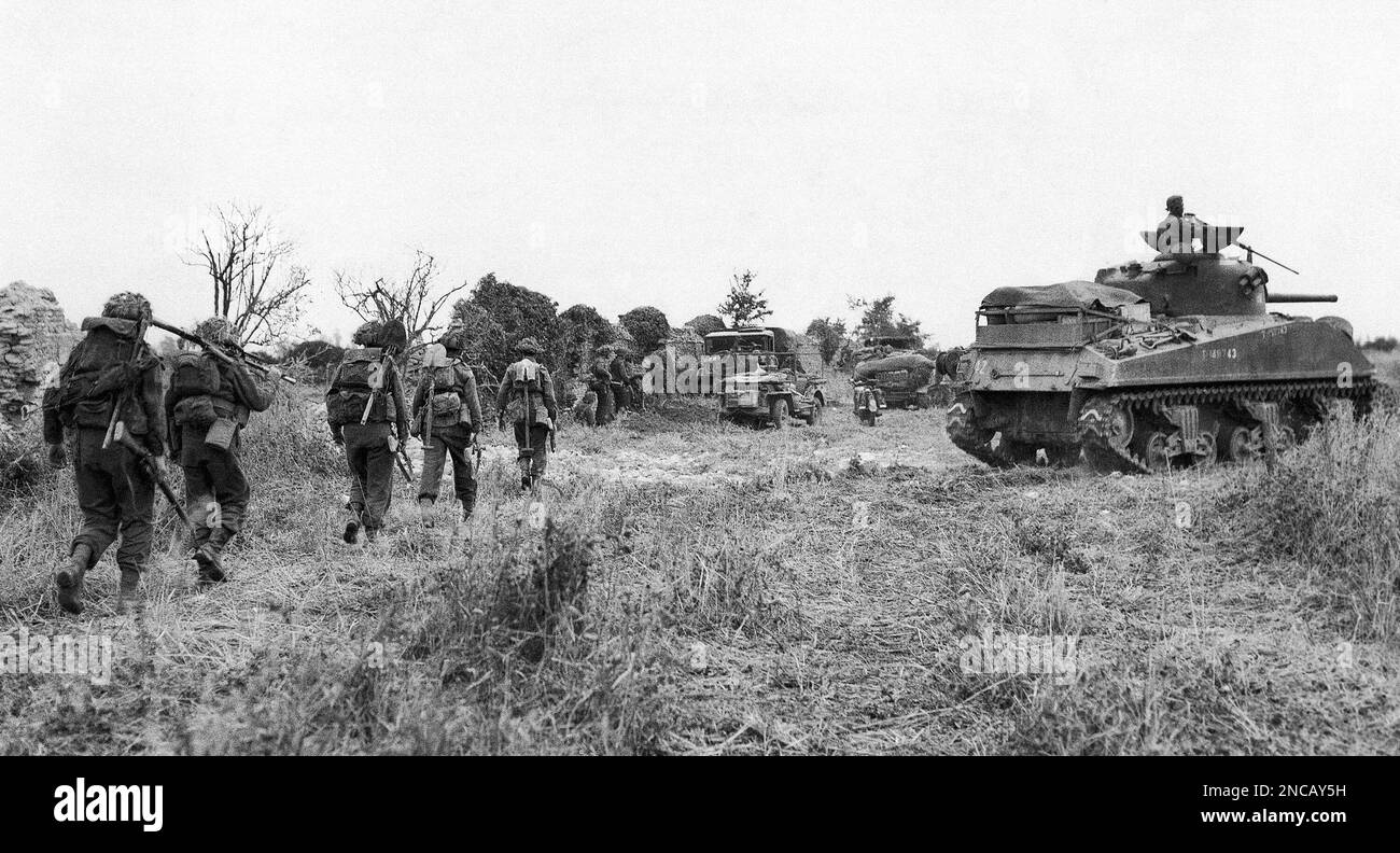 British infantrymen and tanks push on through the village of Gruchy on ...
