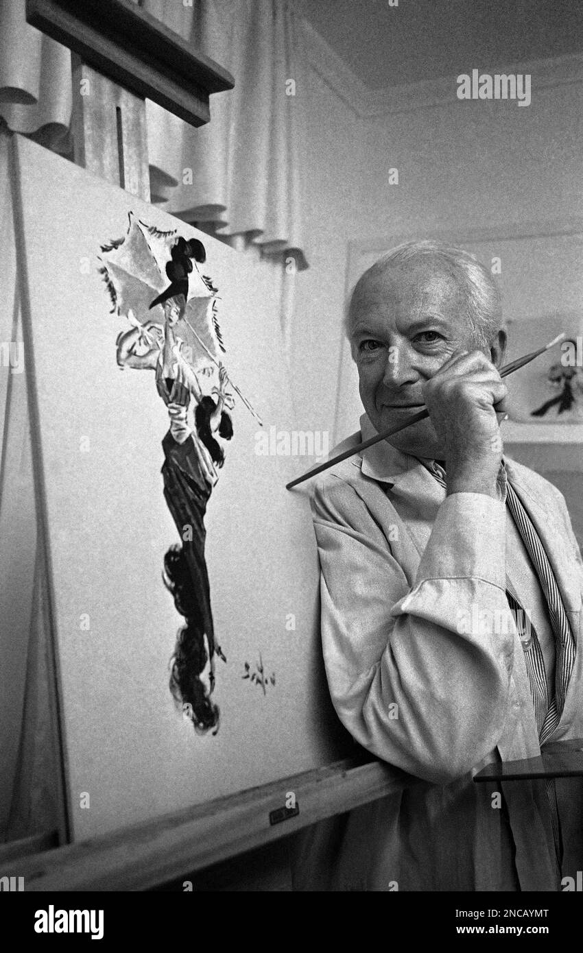 Englishman Cecil Beaton, a man of many distinctions, poses holding a ...