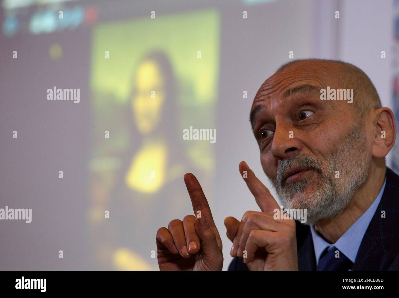 Art historian Silvano Vinceti gestures as a photo of Italian artist ...