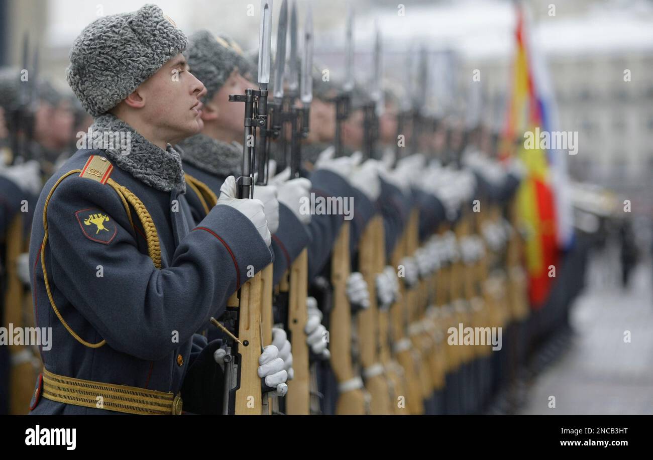 Honor guards present arms during a wreath laying ceremony at a memorial ...
