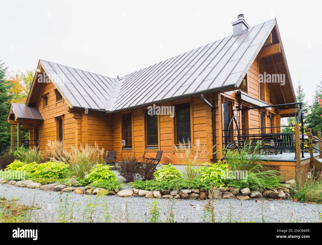 Piece sur piece Scots pine log home facade with brown standing seam ...