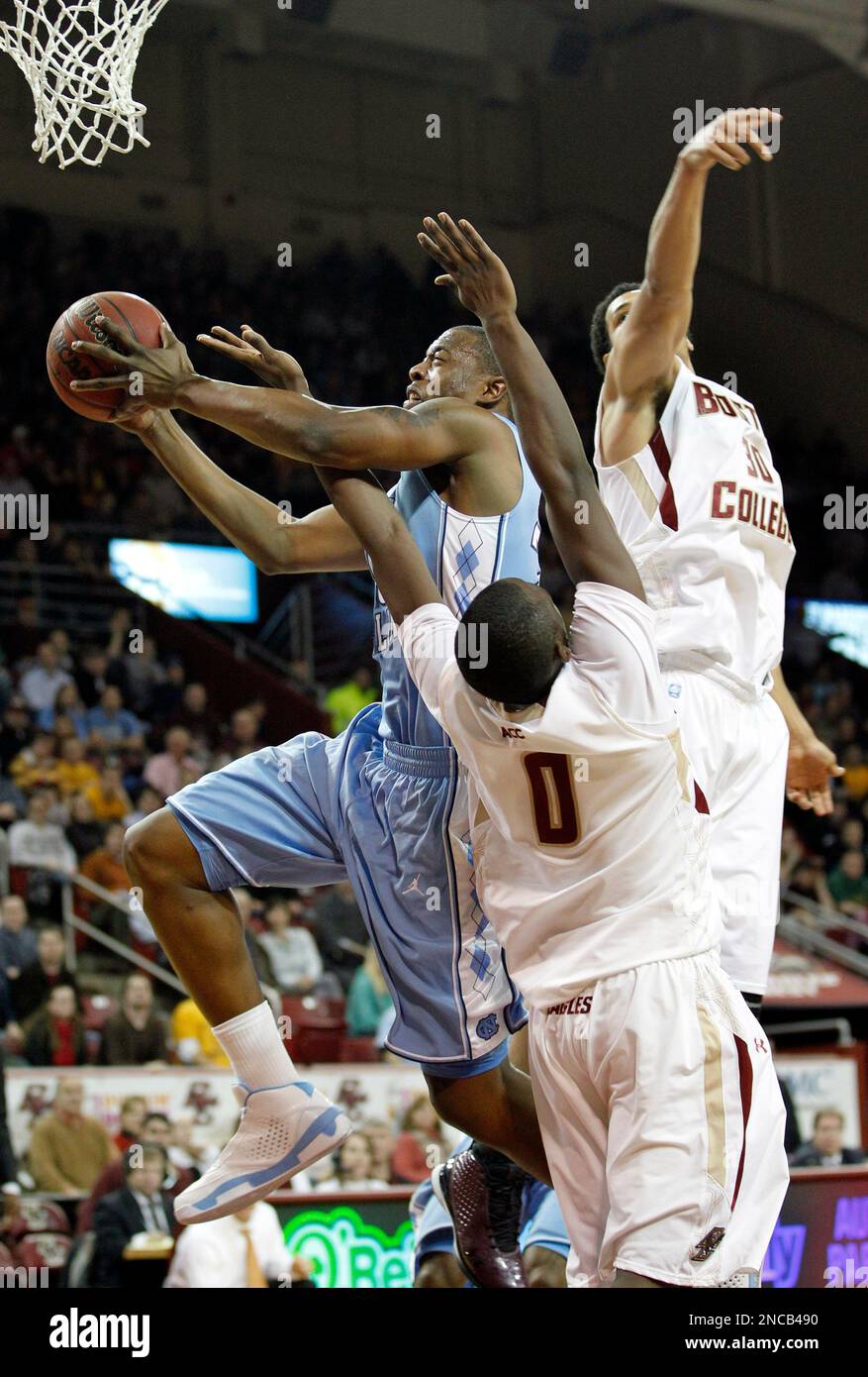 North Carolina's Justin Knox drives to the basket ahead of Boston ...