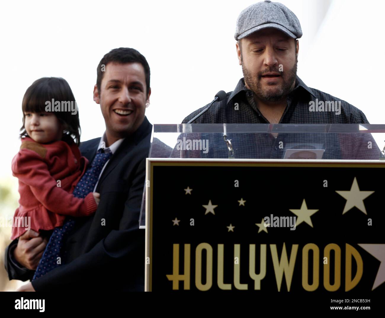 Kevin James, right, introduces Adam Sandler, center, as he holds his ...