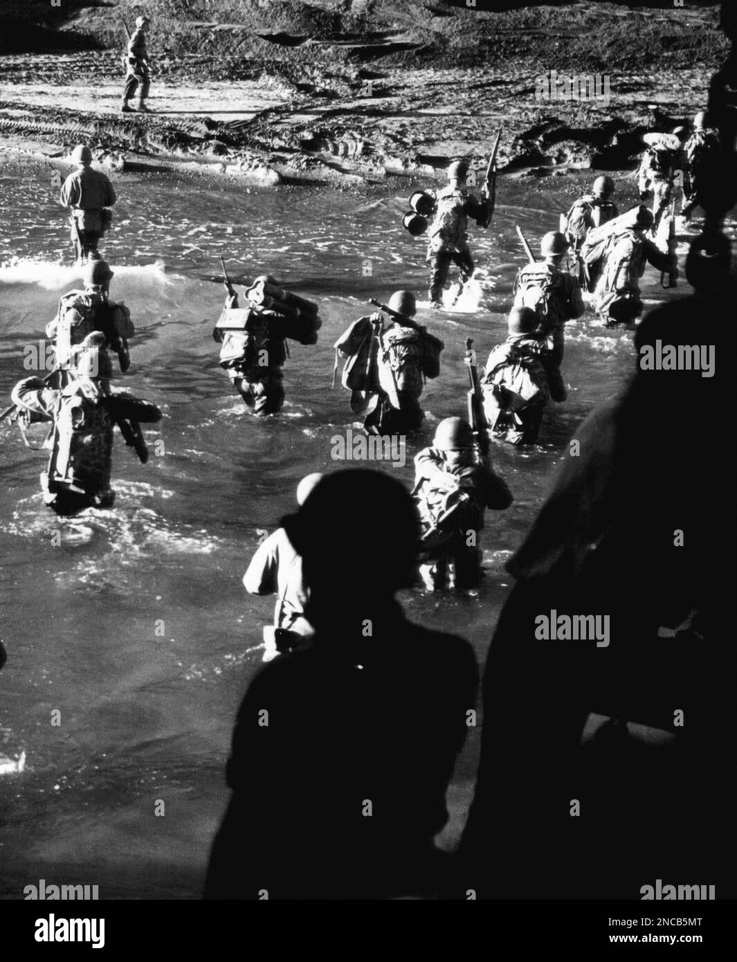 First troops to hit Cape Sansapor spring into the surf from the mouth ...