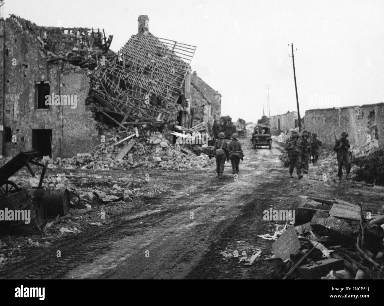 British infantry making their way through the ruined village of Lebisey ...