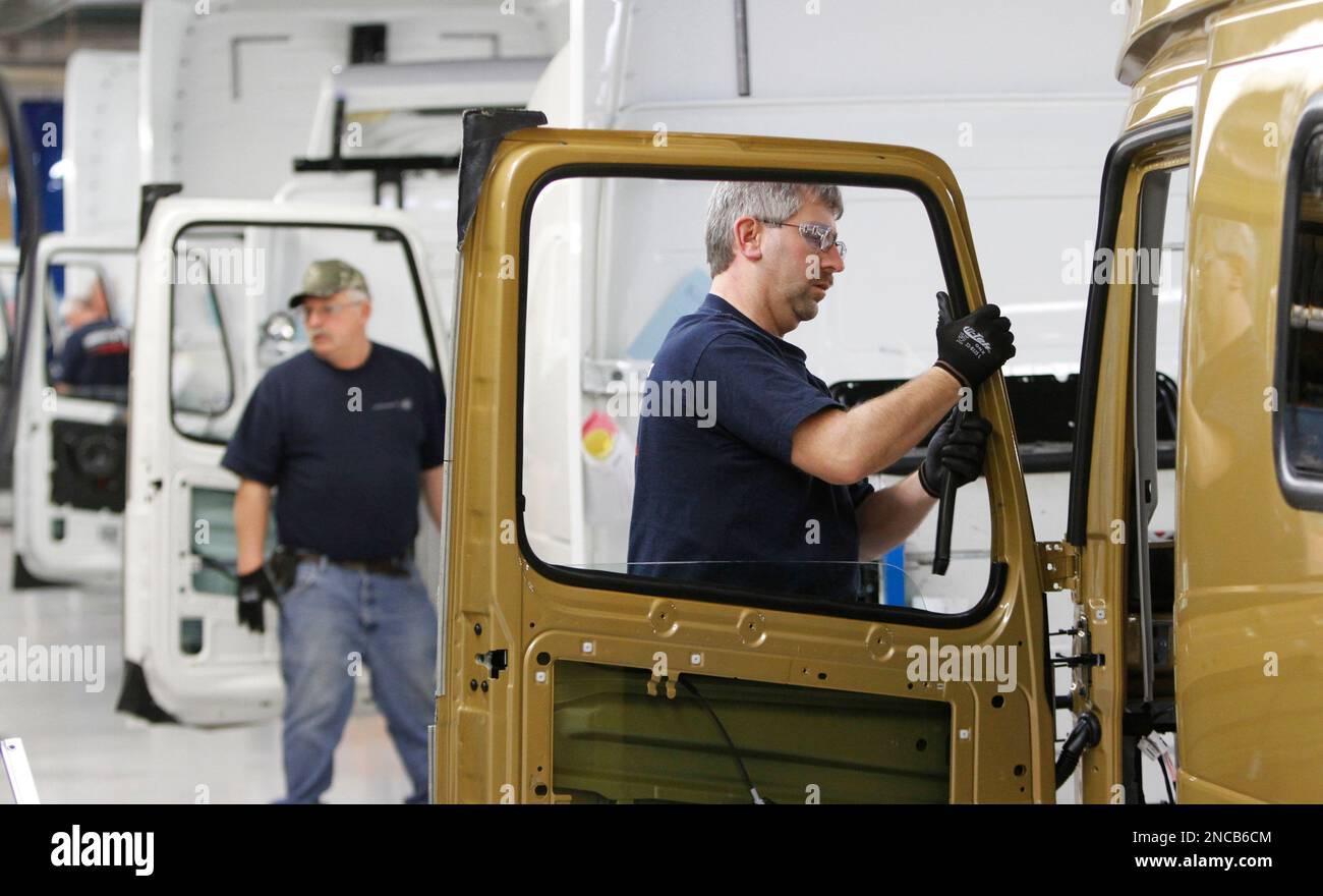 In this Jan. 26, 2011 photo, workers install seals on a door frame on ...