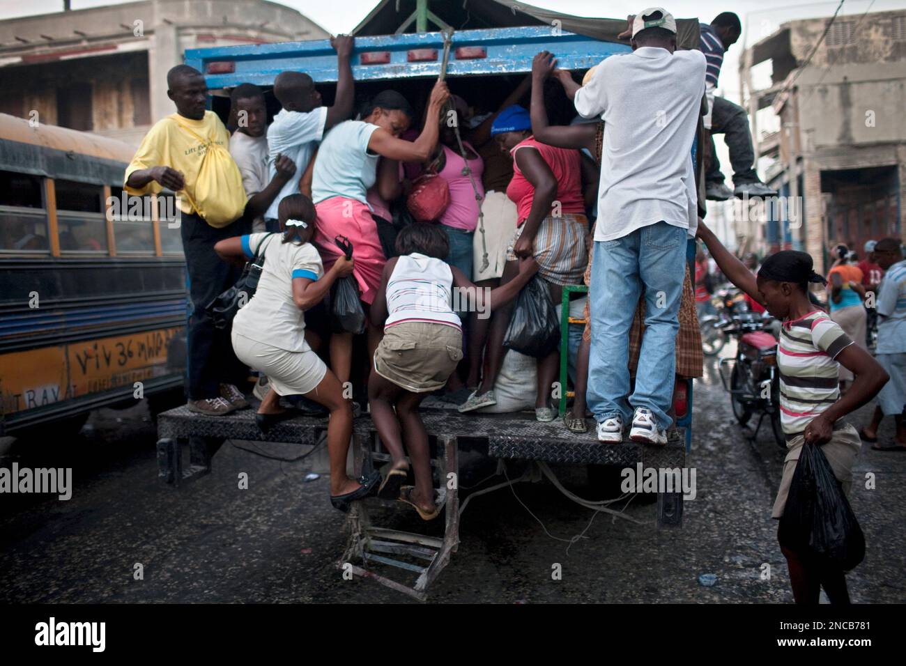 People squeeze into a trailer-truck converted into a form of public ...
