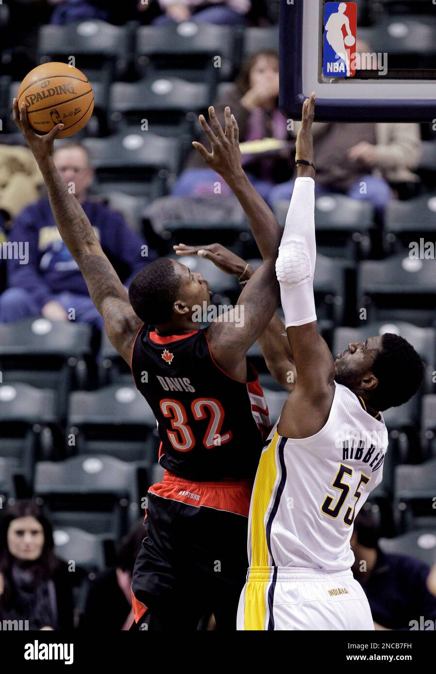 Toronto Raptors forward Ed Davis, left, shoots over Indiana Pacers ...
