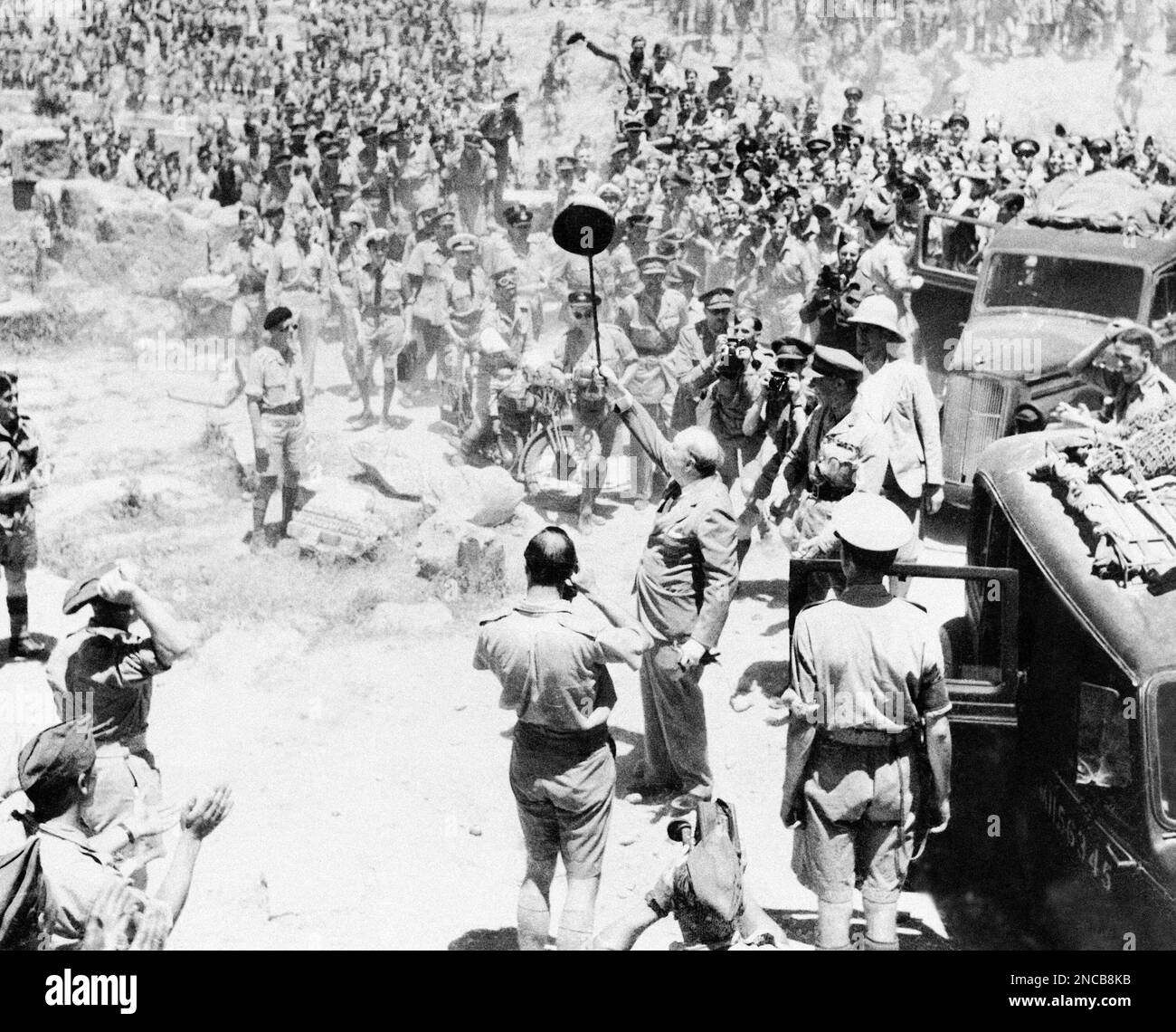 Winston Churchill, British Prime Minister waves his hat on his cane to ...
