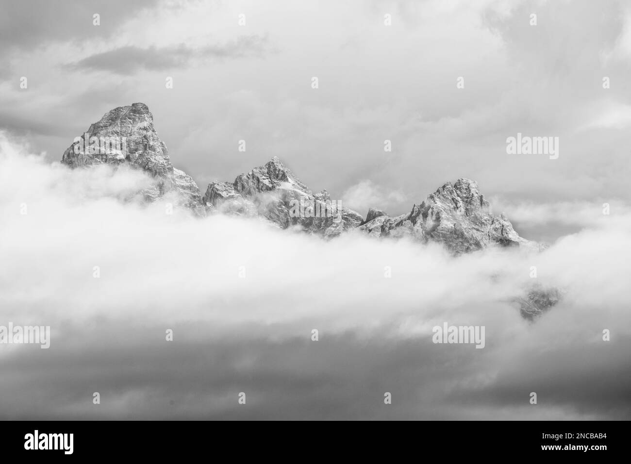 Teton peaks rise above a storm, depicting concepts of hope, faith and ...