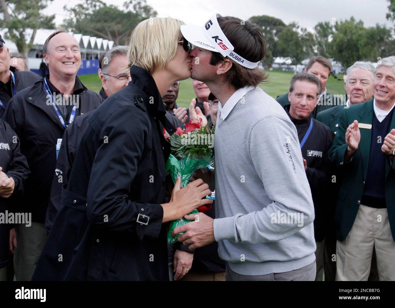 Bubba Watson, right, kisses his wife Angie Watson after winning the ...