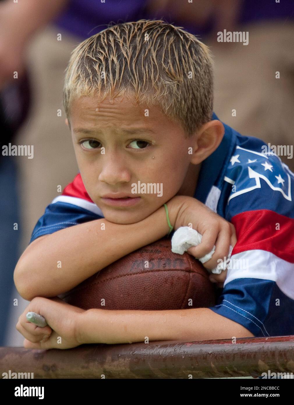 Tanner White, 8, of Aiea, Hawaii, watches the NFC squad warm up for NFL ...