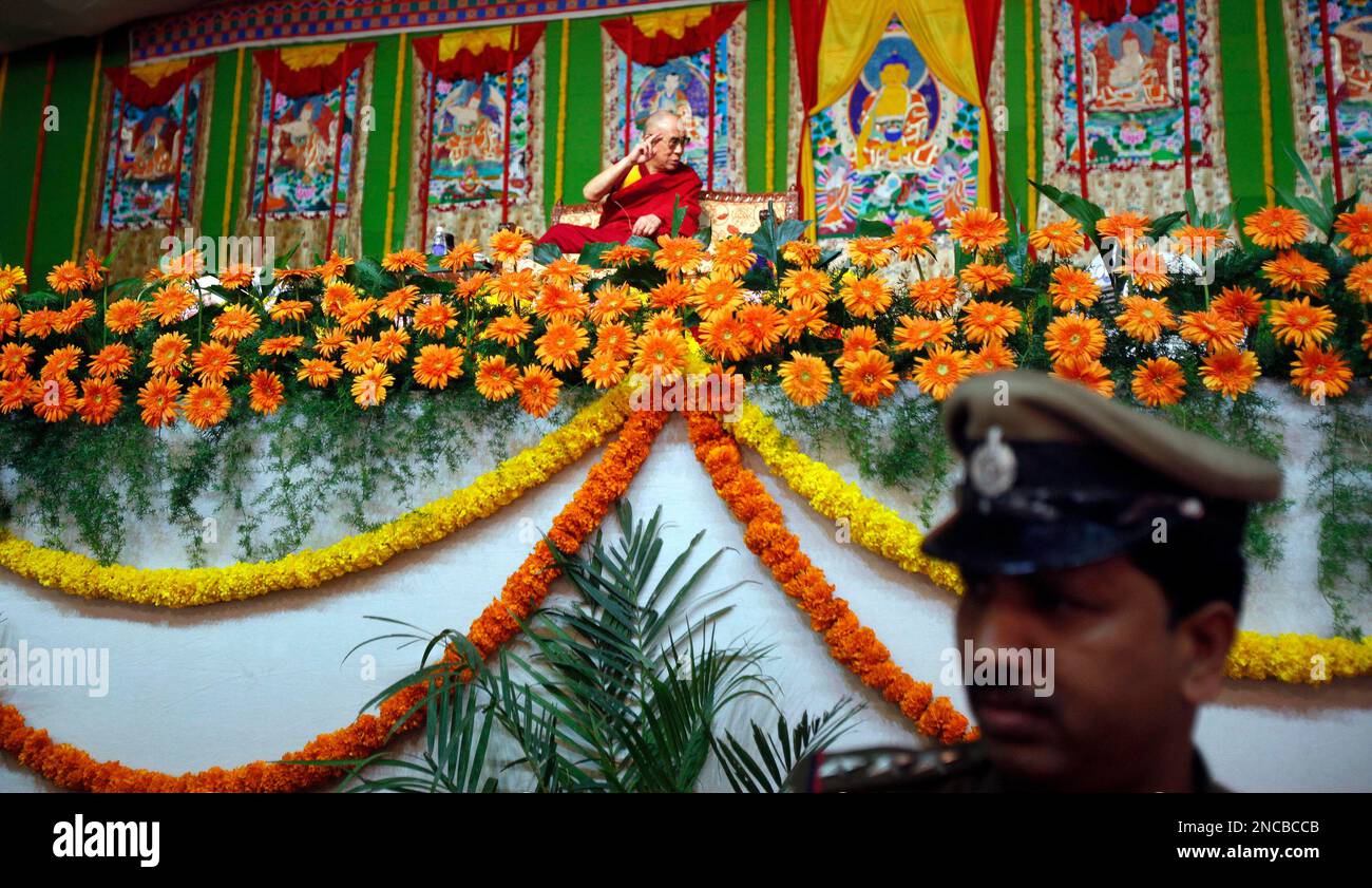 An Indian police officer stands guard as Tibetan spiritual leader the ...