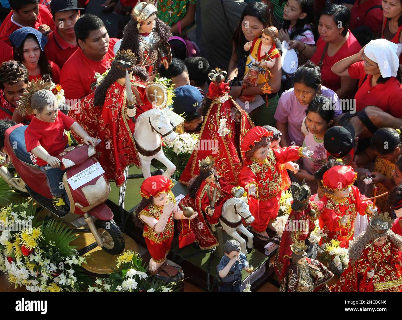 Catholic devotees display different images of the Child Jesus during a ...