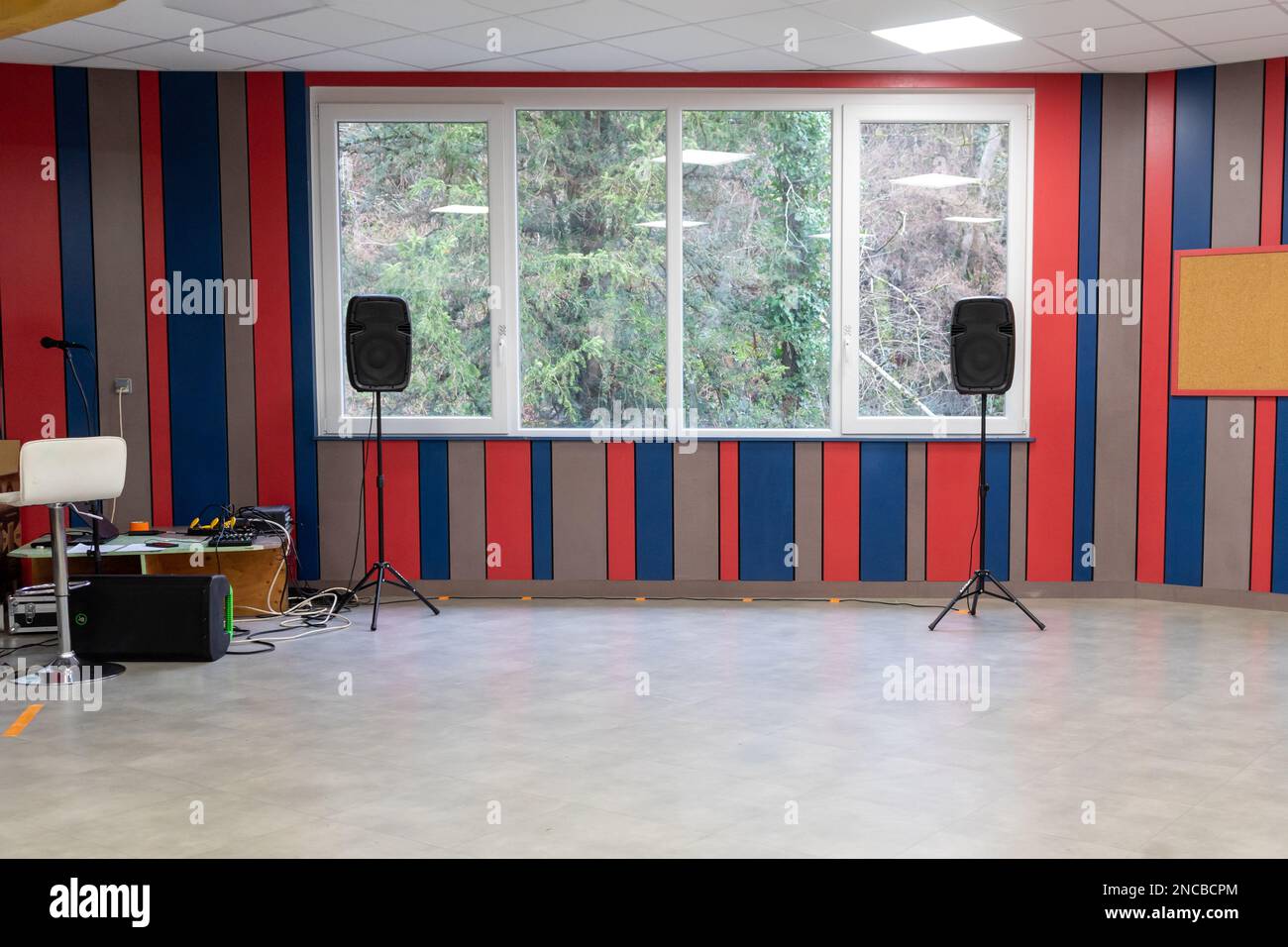 An empty event space with a large window and two columns without people ...