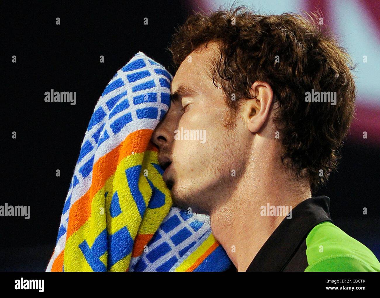 Britain's Andy Murray wipes the sweat from his face in his match ...