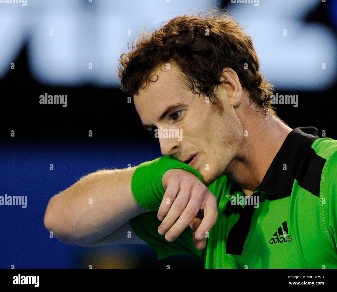 Britain's Andy Murray wipes the sweat from his face in his match ...