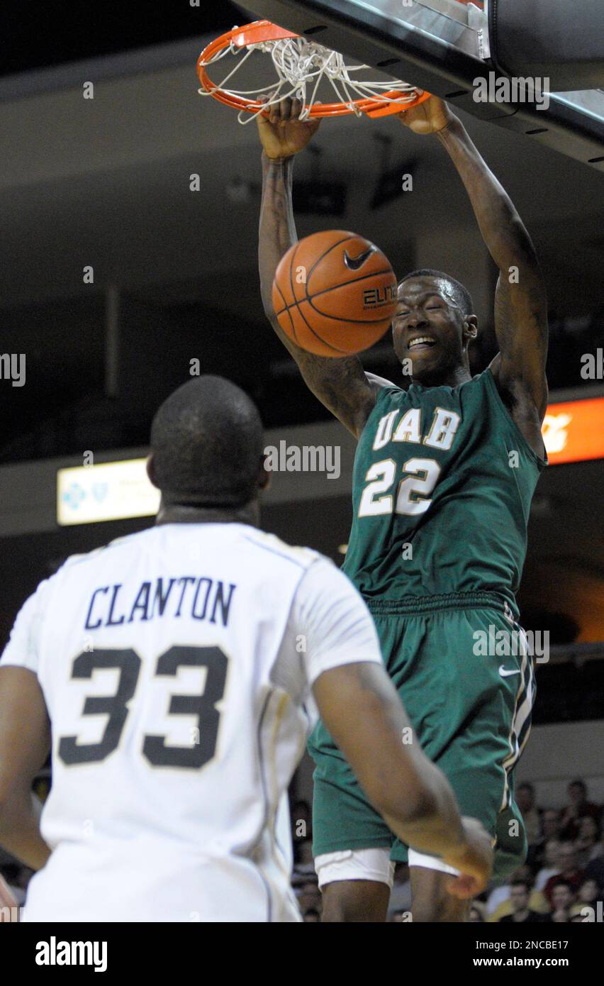 UAB forward Cameron Moore, right, dunks the ball in front of Central ...