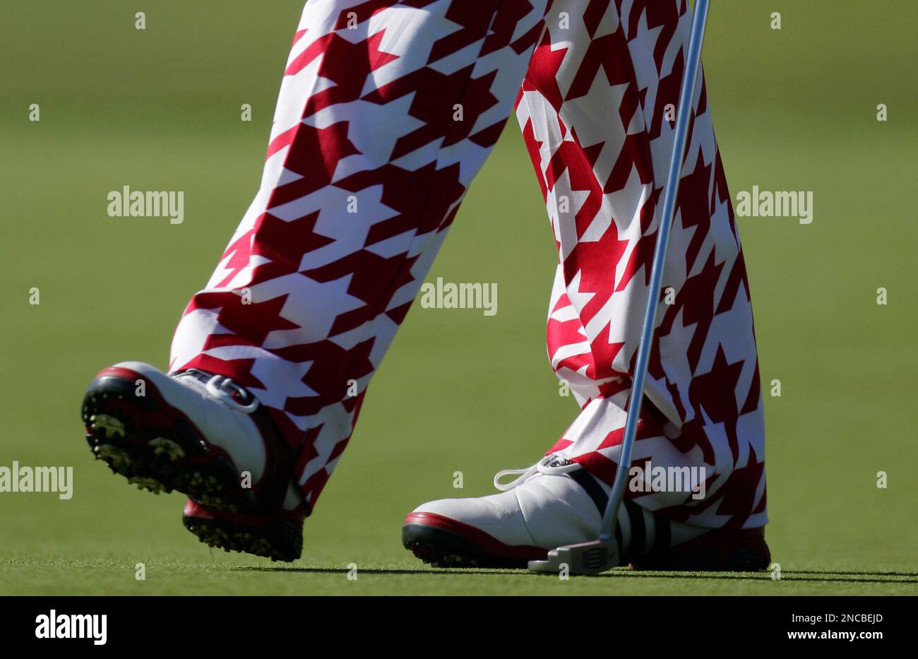 The colorful pants of John Daly as he strolls across the sixth green of ...