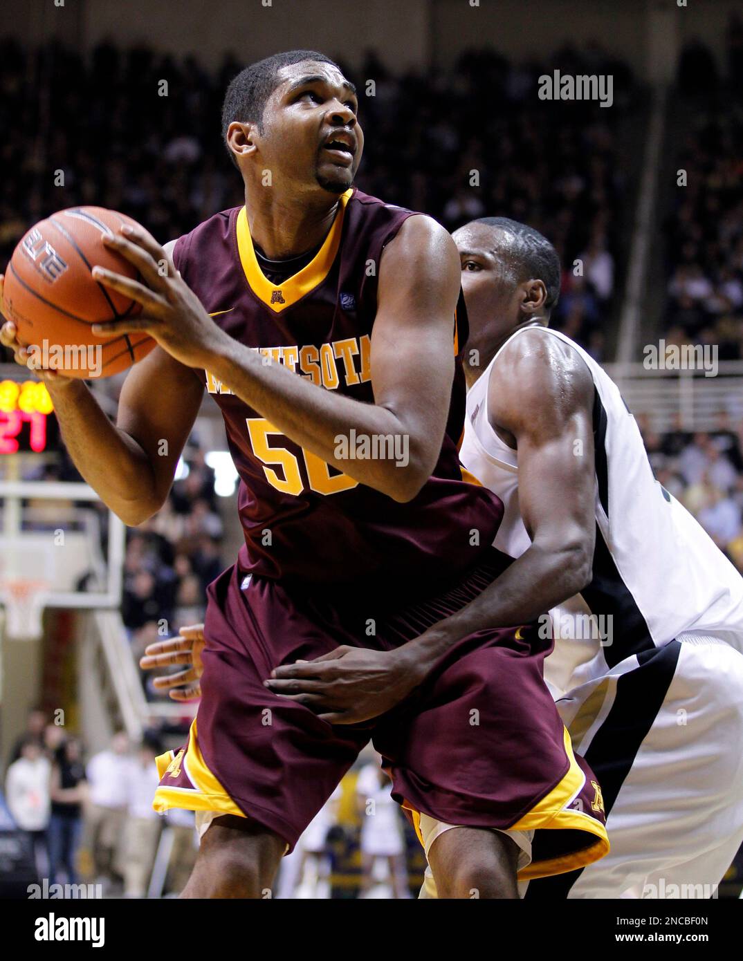 Purdue center JaJuan Johnson, right, defends against Minnesota center ...