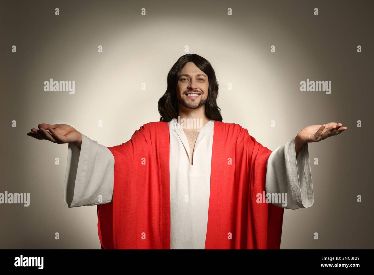 Jesus Christ reaching out his hands on beige background Stock Photo - Alamy