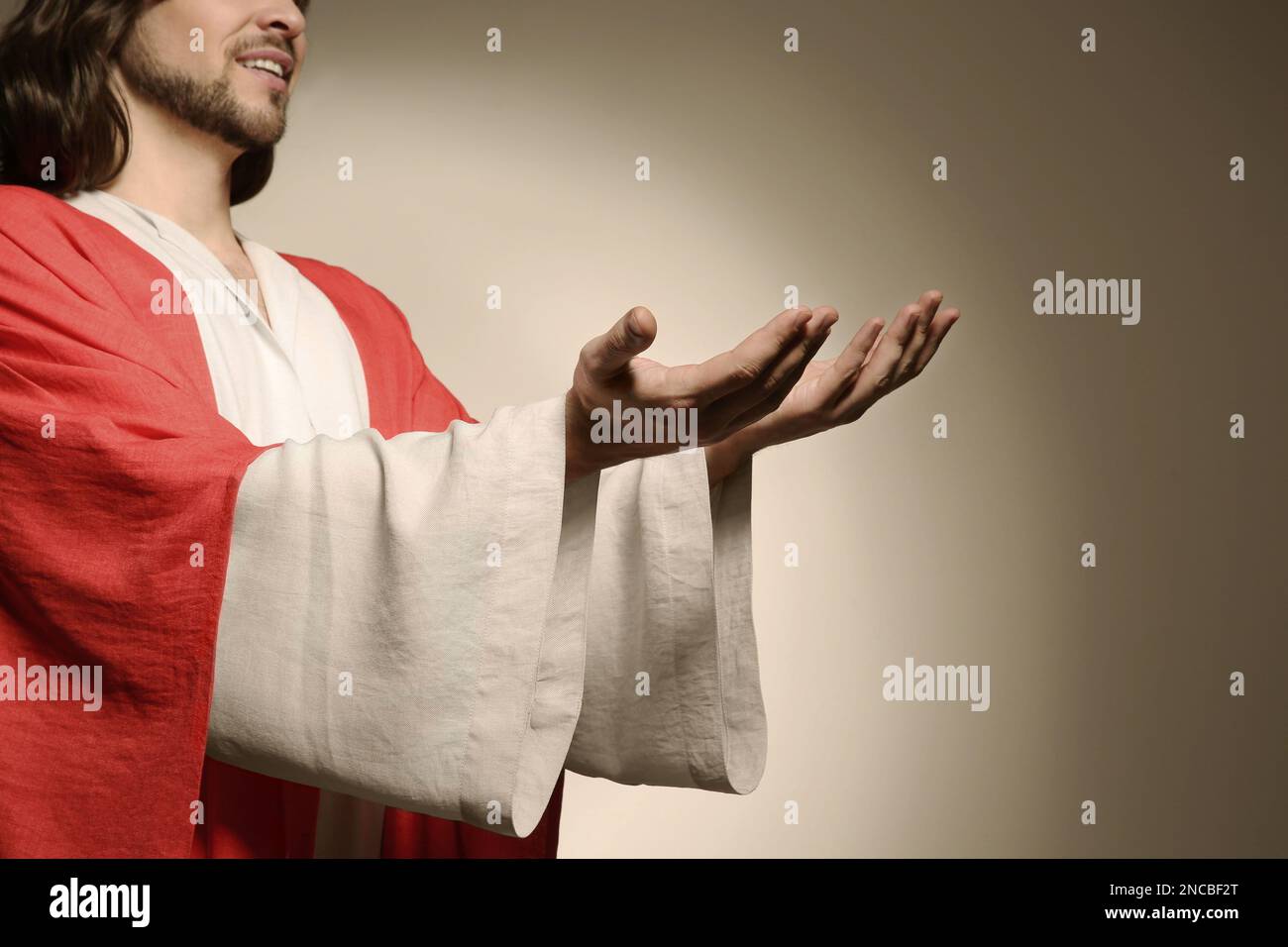 Jesus Christ reaching out his hands on beige background, closeup Stock ...