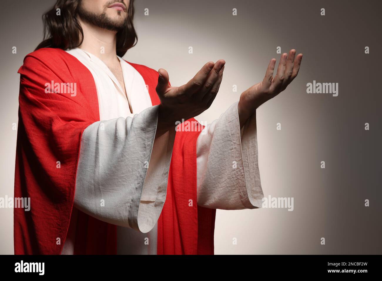 Jesus Christ reaching out his hands on beige background, closeup Stock ...
