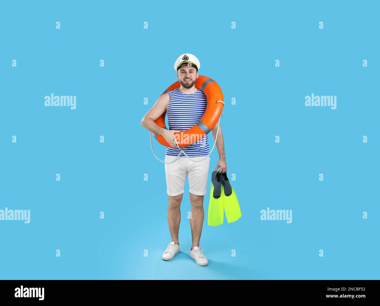 Sailor with ring buoy and swim fins on light blue background Stock ...