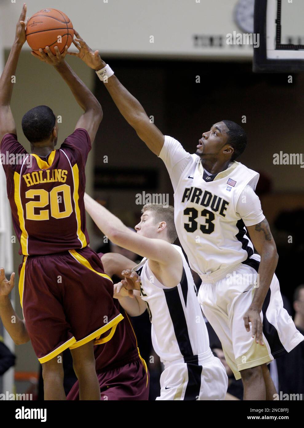 Purdue guard E'Twaun Moore, right, reaches to block a shot by Minnesota ...