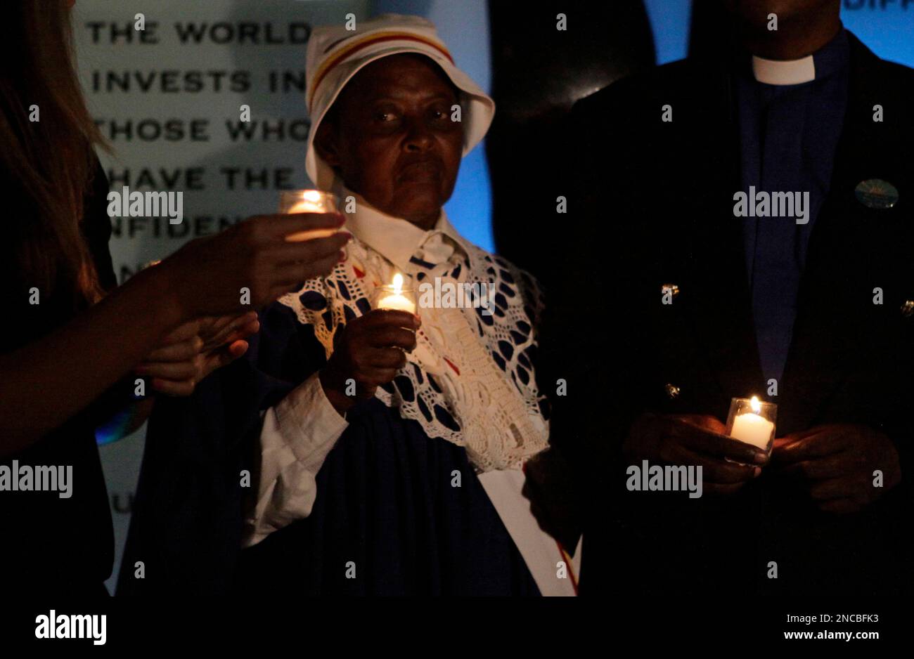 A worshipper in Johannesburg lights a candle in prayer for the recovery ...