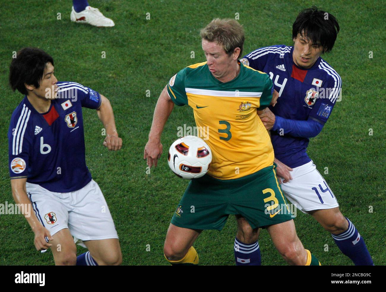 Australia's David Carney, center, vies for the ball with Japan's Daiki ...