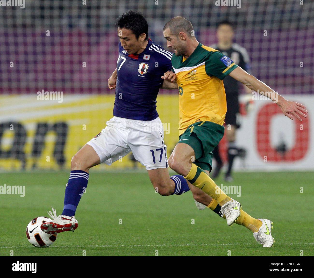 Japan's Makoto Hasebe, left, and Australia's Carl Valeri in action ...